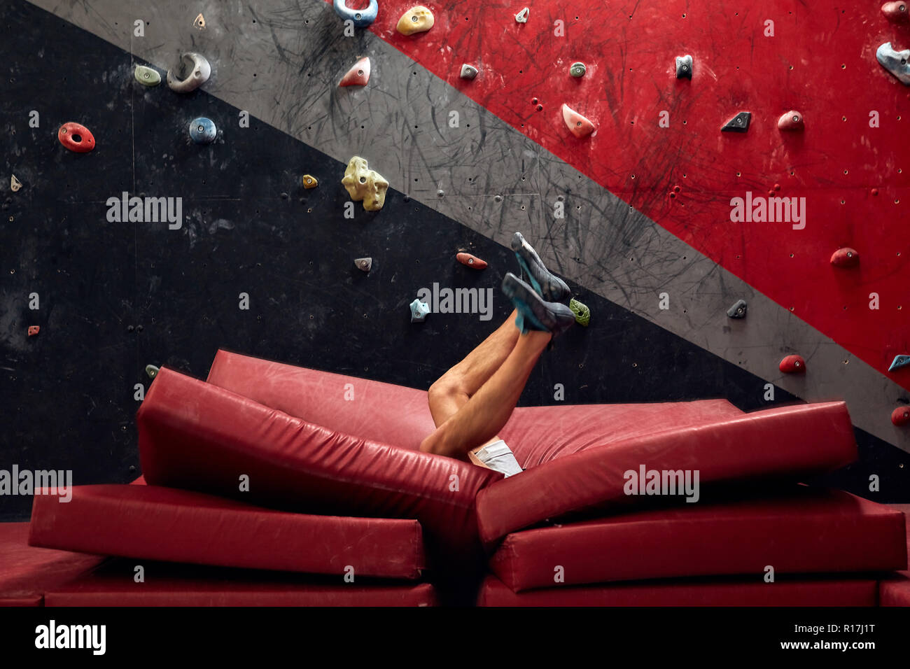 Panoramic man bouldering at an indoor climbing centre Stock Photo - Alamy