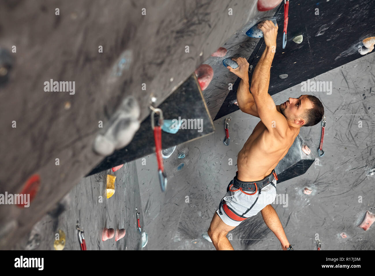 Panoramic man bouldering at an indoor climbing centre Stock Photo - Alamy