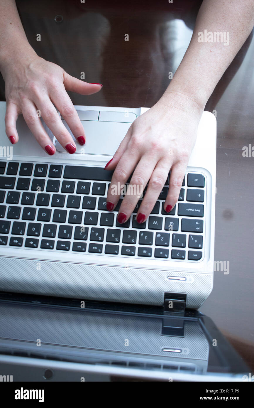 Secretary typist typing on laptop pc computer keyboard keys with hands ...