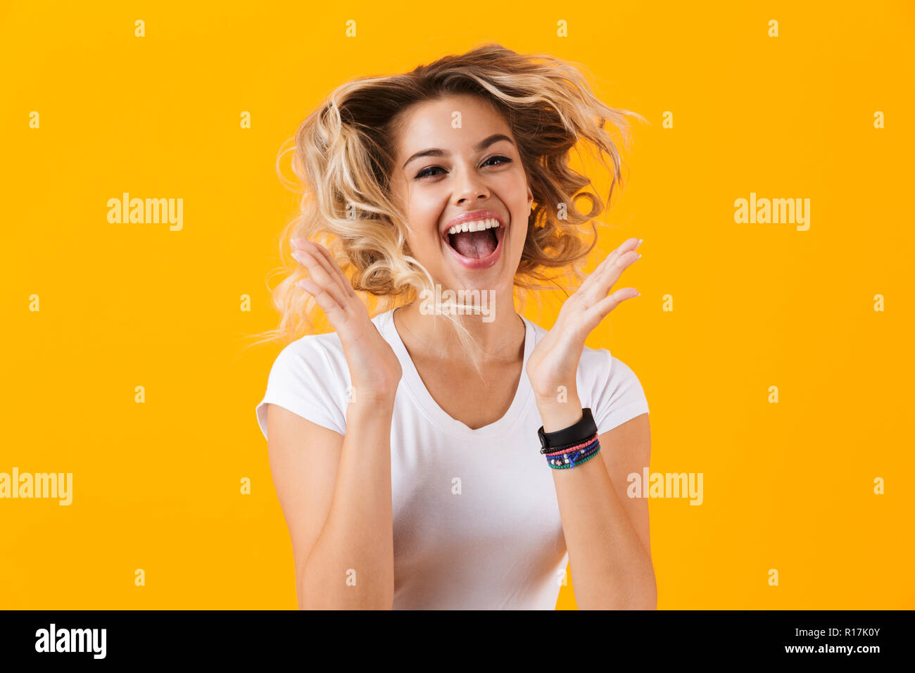 Photo of surprised woman in basic clothing screaming and laughing ...