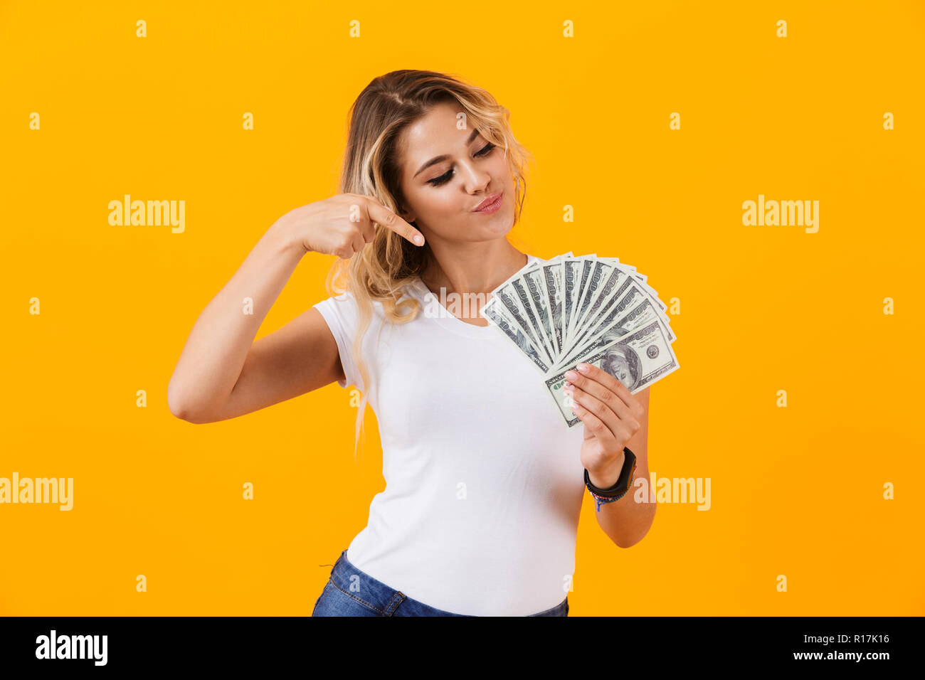 Photo of gorgeous woman in basic clothing holding fan of dollar money ...
