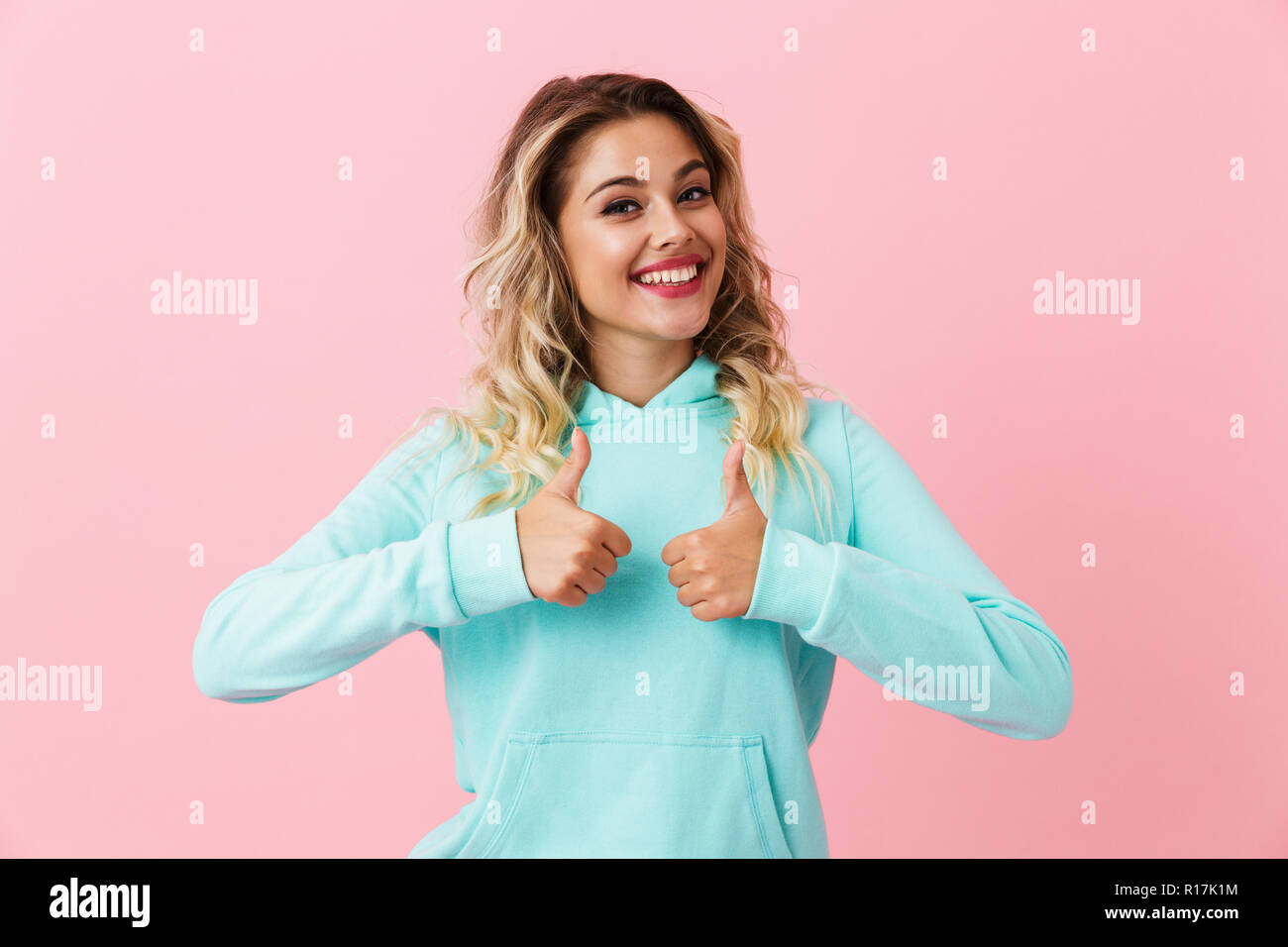 Photo of kind woman in basic clothing laughing and showing thumbs up ...