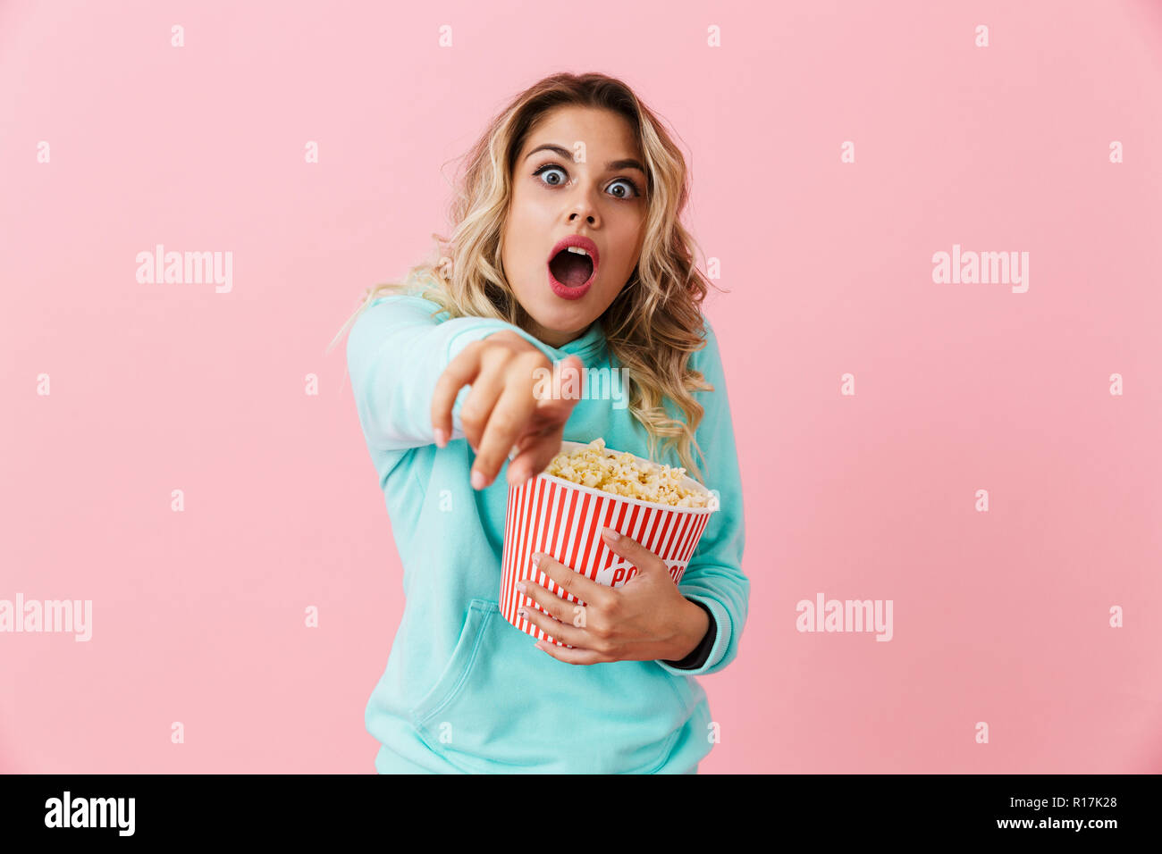 Image of young european woman 20s screaming and holding bucket with ...