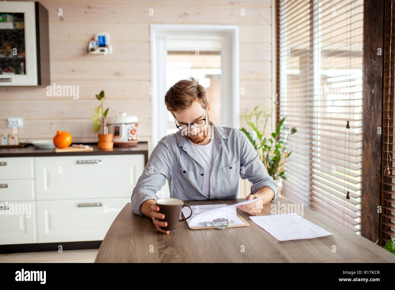 Serious applicant sitting in boardroom, preparing for interview with ...
