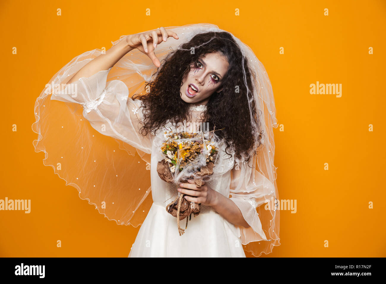 Creepy dead bride in white wedding dress looking camera and scary ...