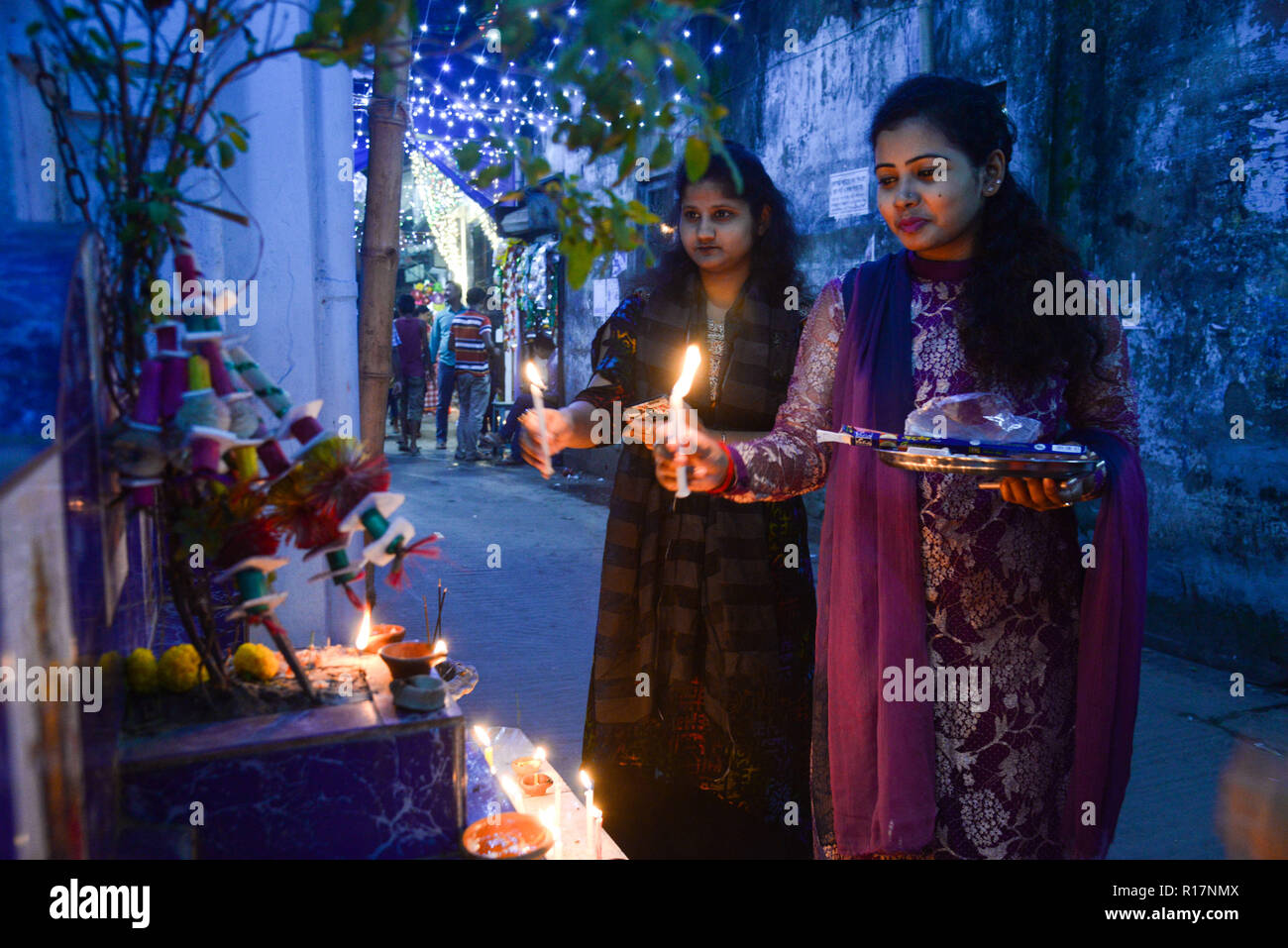 Hindu devotees light up oil lamp and candle to celebrate Diwali, the ...