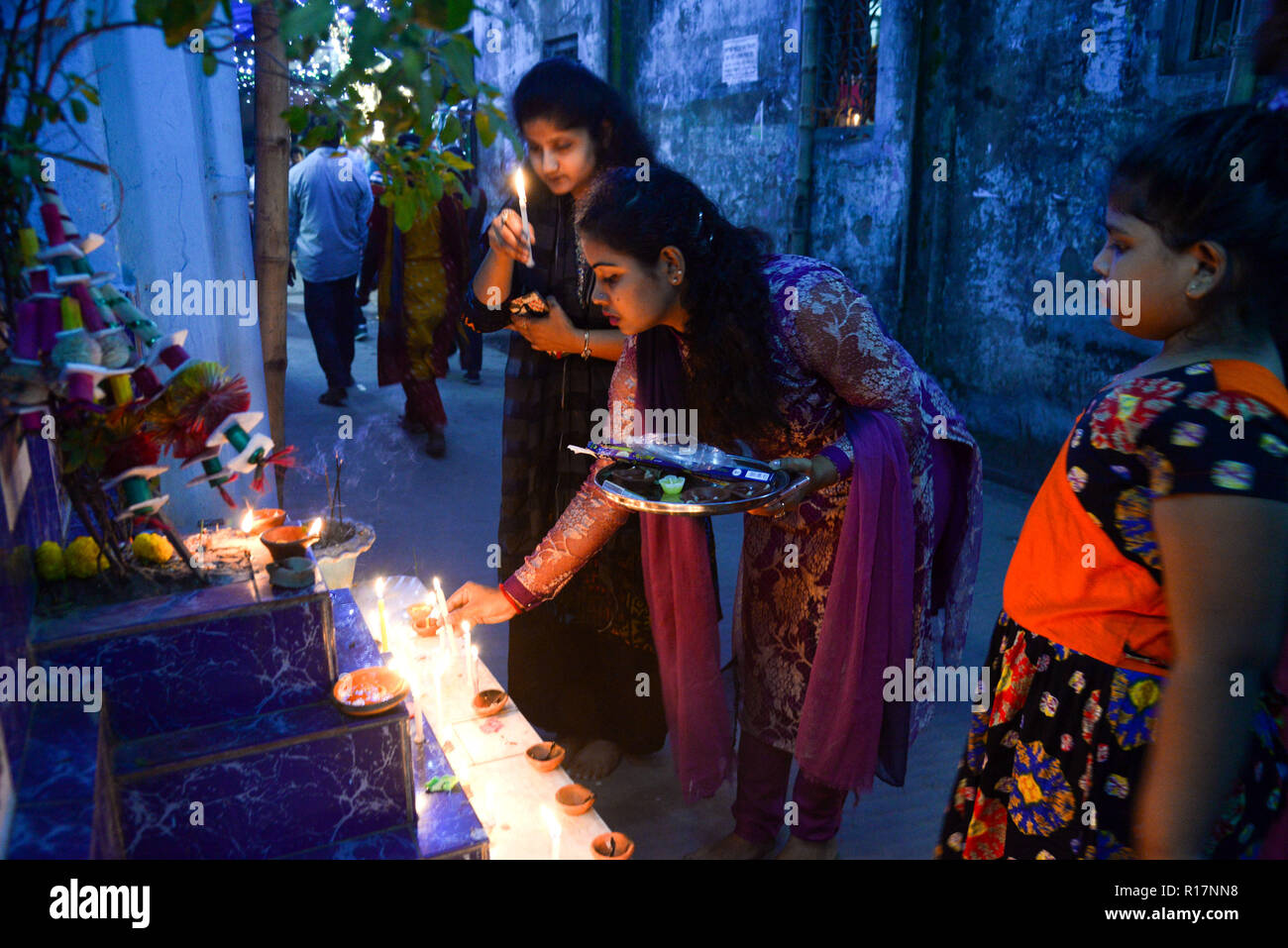 Hindu devotees light up oil lamp and candle to celebrate Diwali, the ...