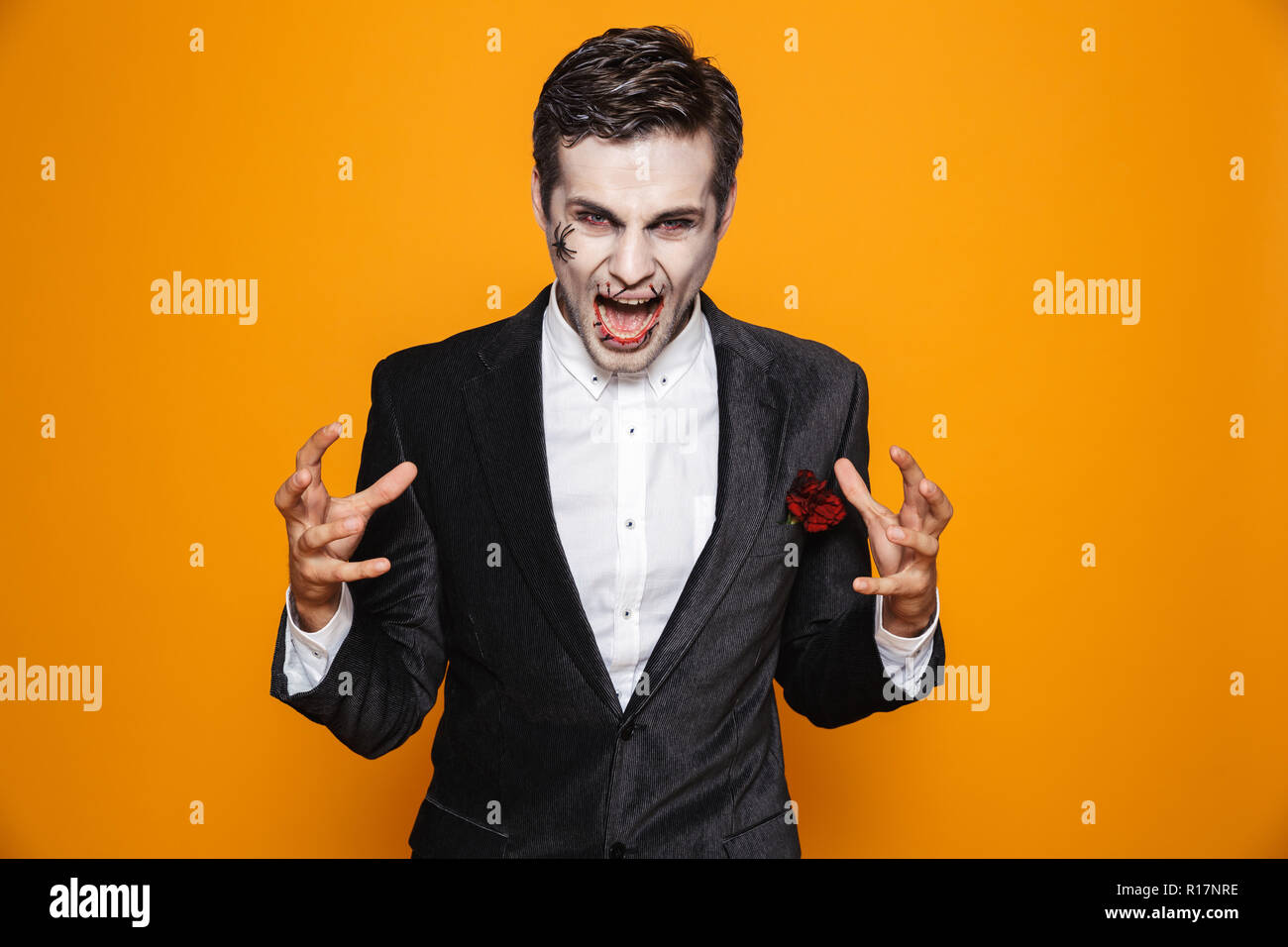 Angry psycho man zombie in suit screaming and looking camera isolated ...