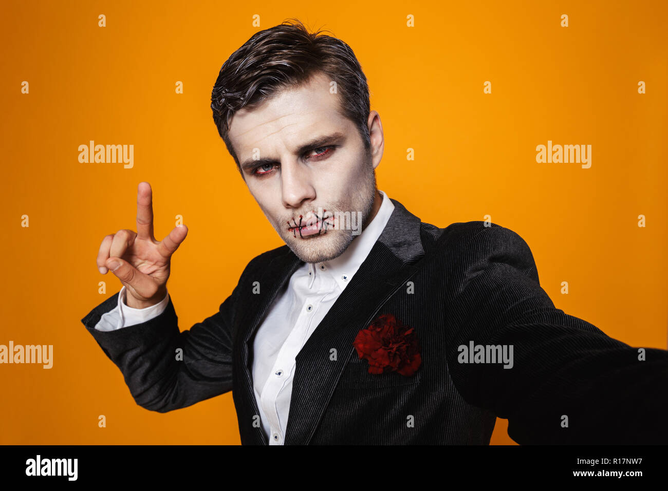 Photo of scary zombie man on halloween wearing classical suit and ...