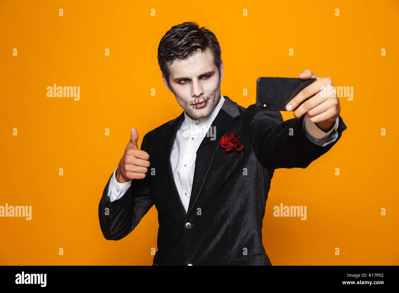 Photo of scary dead man on halloween wearing classical suit and creepy ...