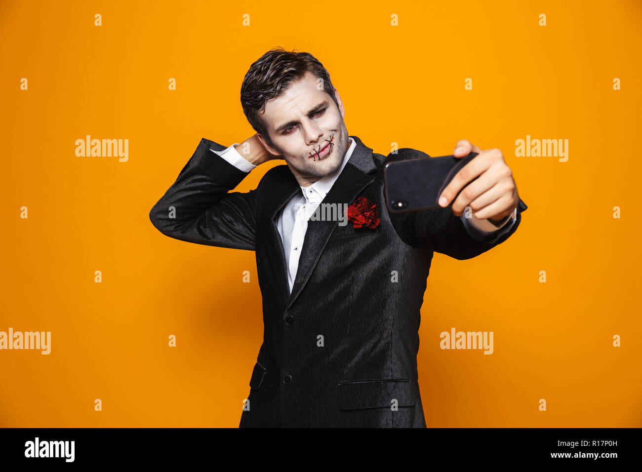 Photo of terrifying dead man on halloween wearing classical suit and ...
