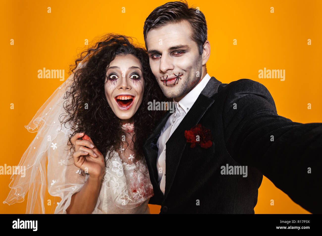 Photo of amusing zombie couple bridegroom and bride wearing wedding ...
