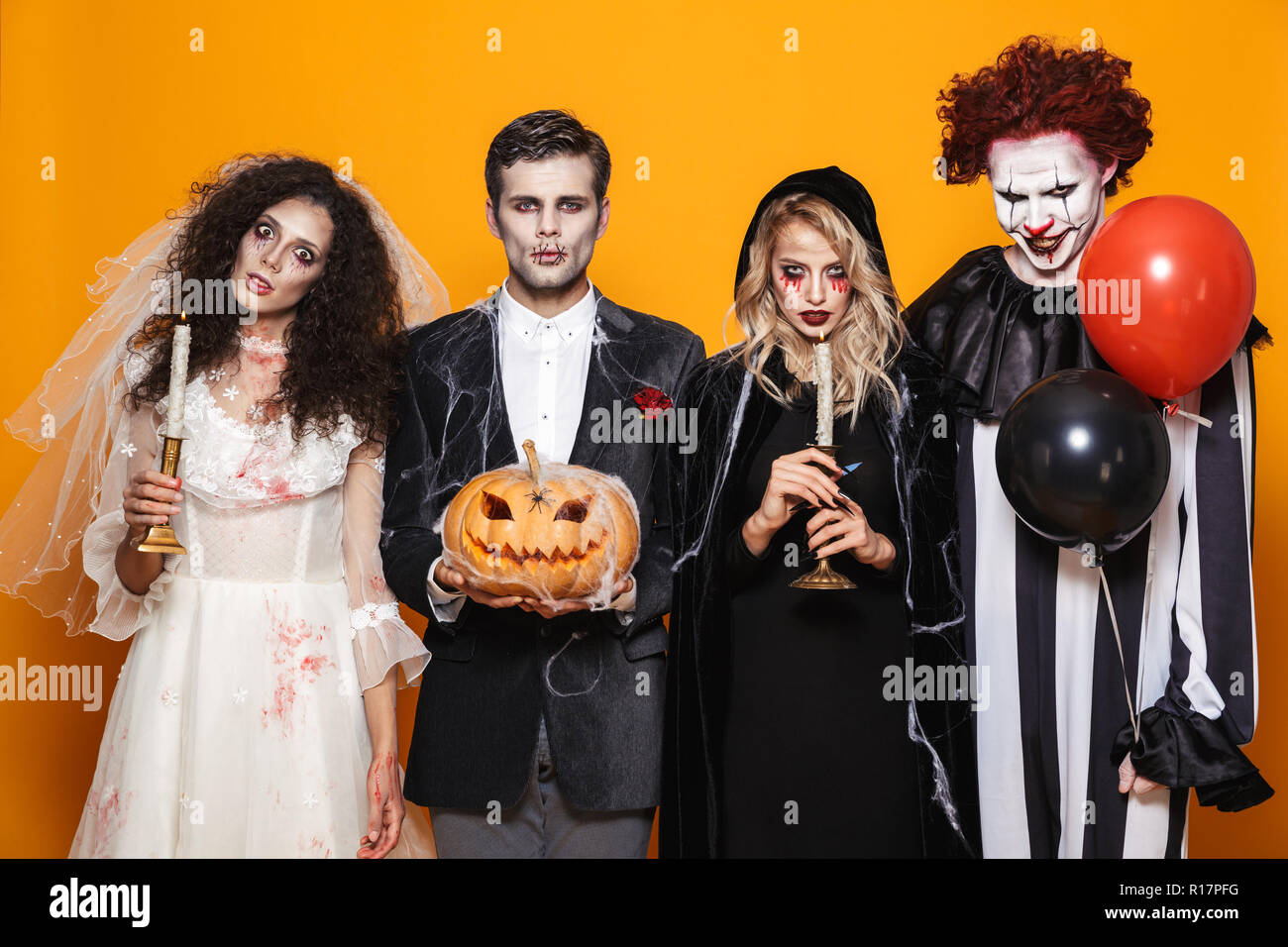 Group of friends dressed in scary costumes celebrating Halloween ...