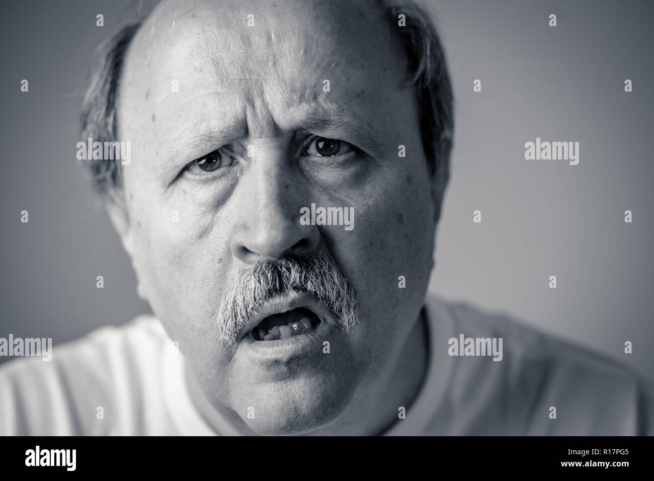 Close up portrait of senior man looking confused and lost suffering ...