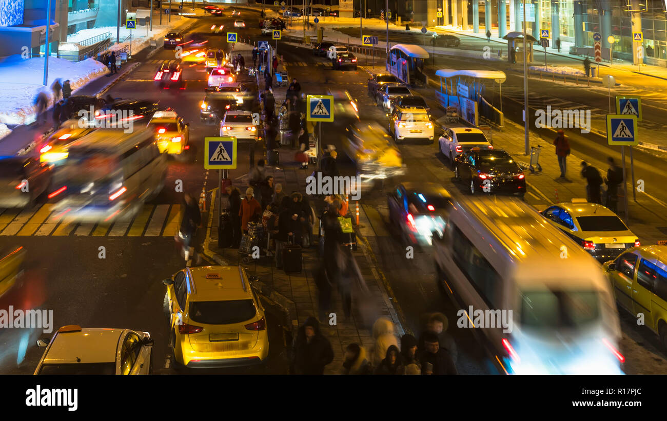 Crowds of people and the flow of taxis at the exit of the airport Stock ...