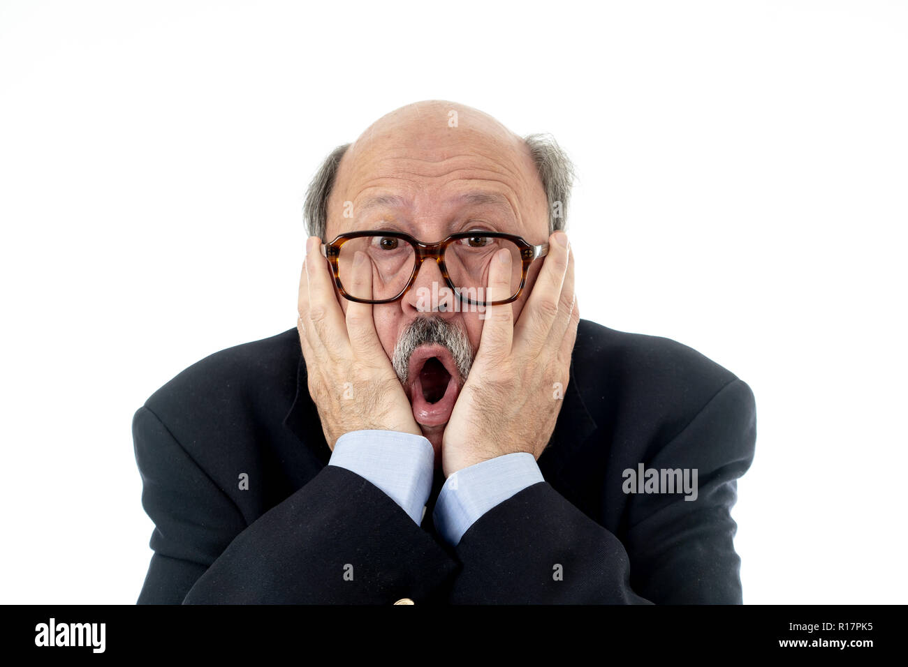 Portrait of a 60s senior man in shock with a scared expression on his ...