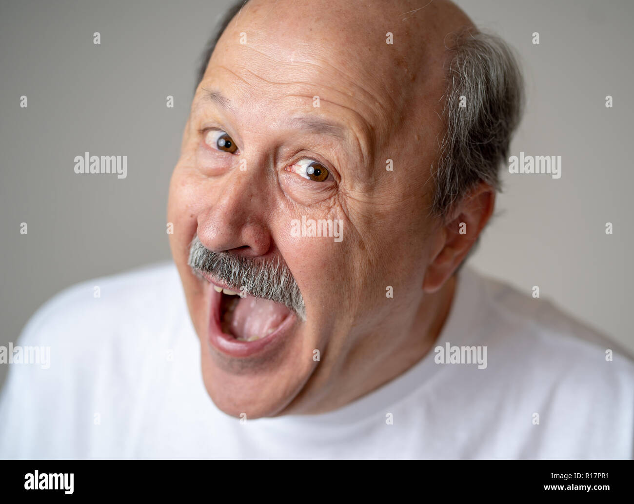 Portrait of happy and cheerful senior mature man smiling and excited ...