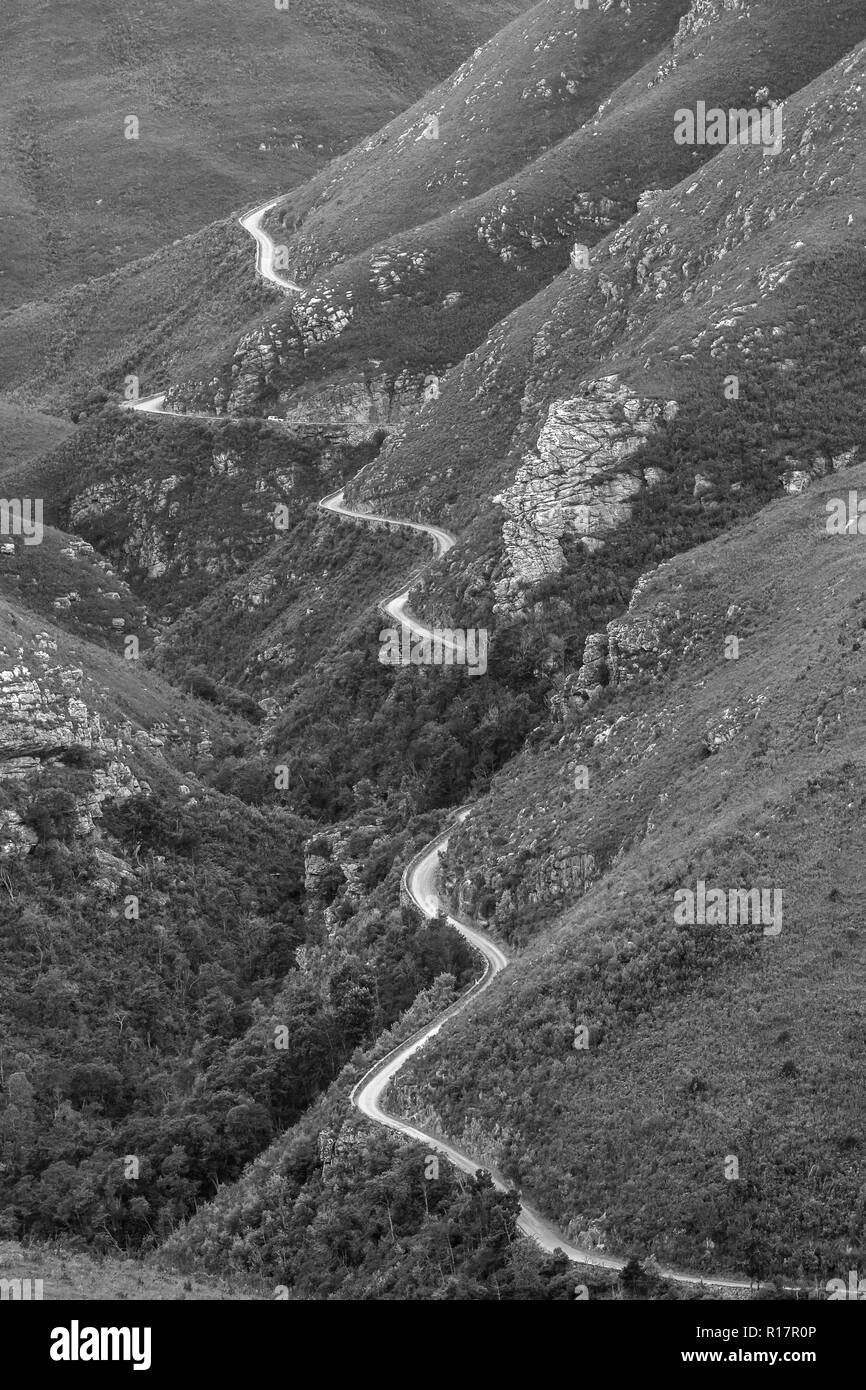High rugged old dirt road pass through rugged mountains in black and ...