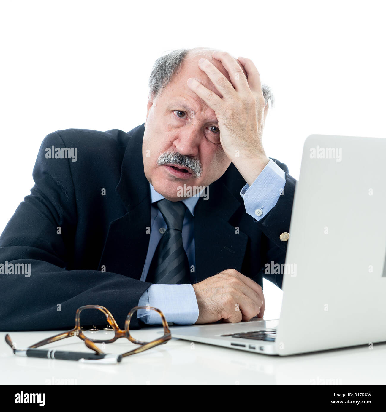 Angry and tired mature businessman overworked at desk not understanding ...
