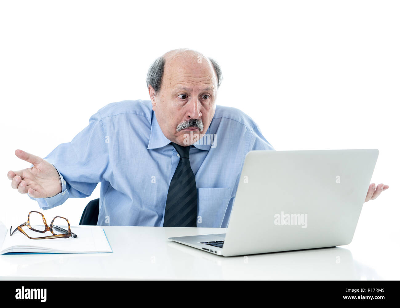 Angry and tired mature businessman overworked at desk not understanding ...