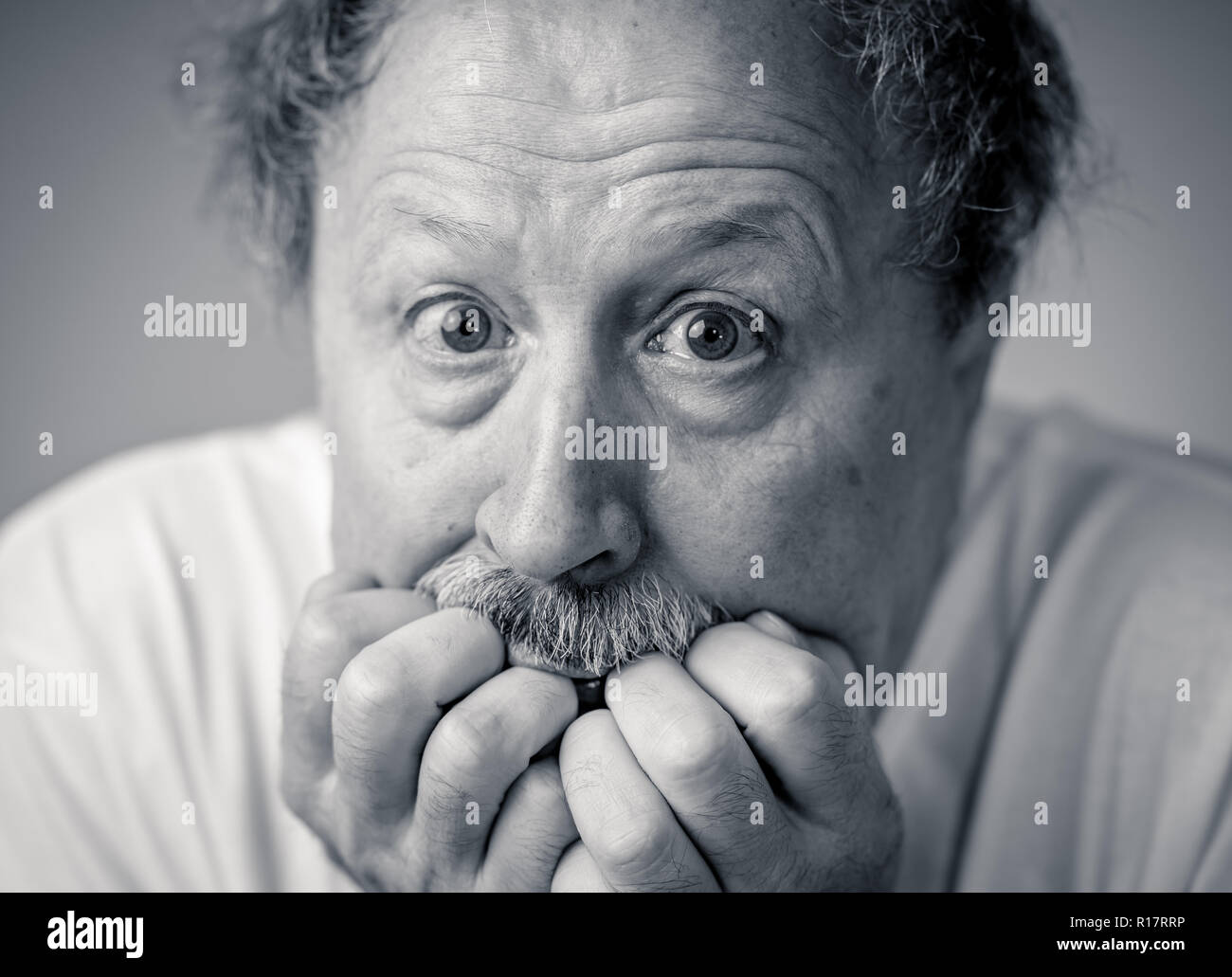 Close up portrait of a scared frightened old man in expression of fear ...