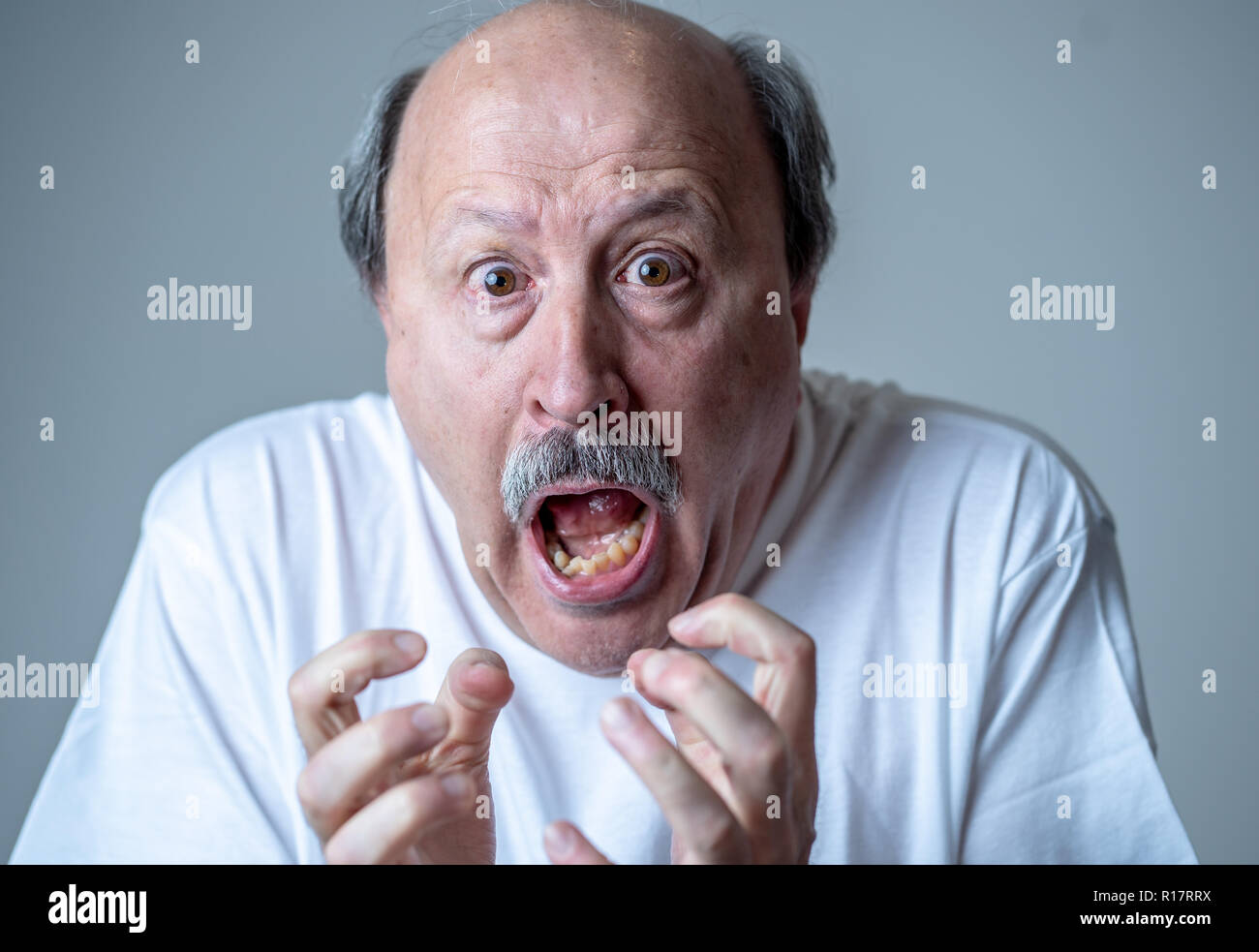 Close up portrait of a scared frightened old man in expression of fear ...