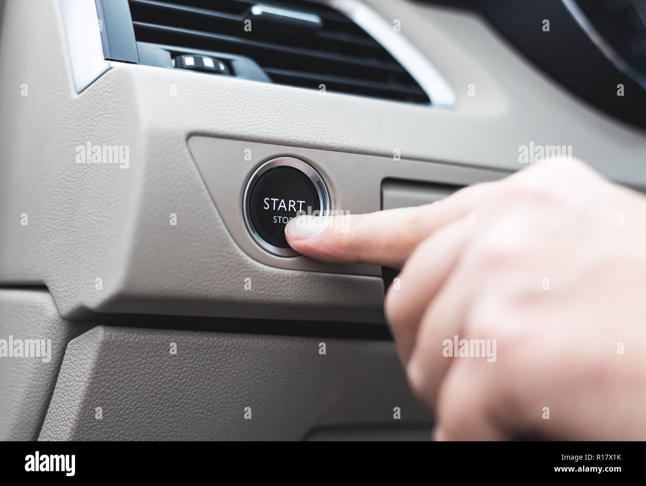 Car start stop system with finger pressing the button, horizontal image ...