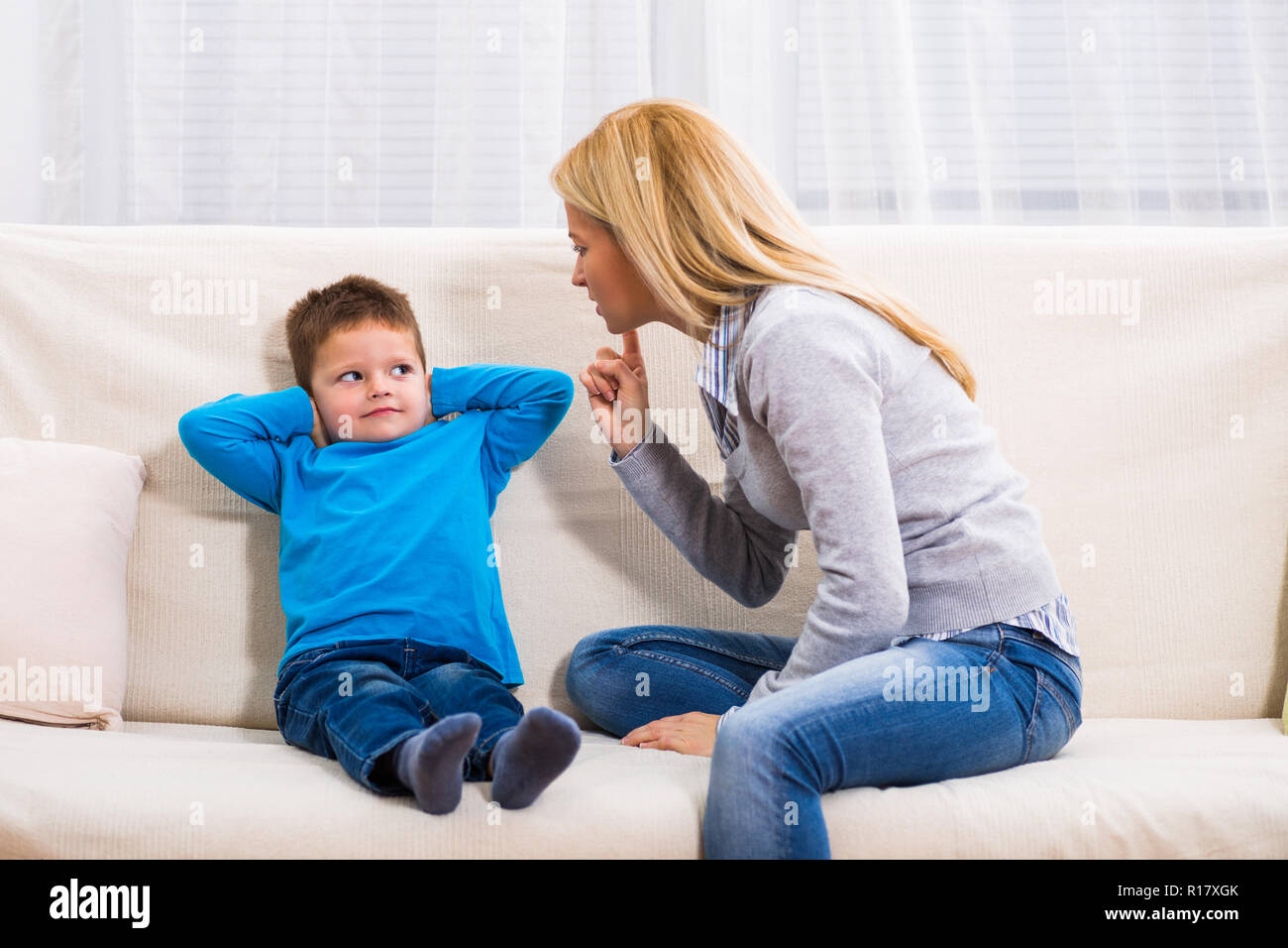 Angry mother is scolding at her son Stock Photo - Alamy