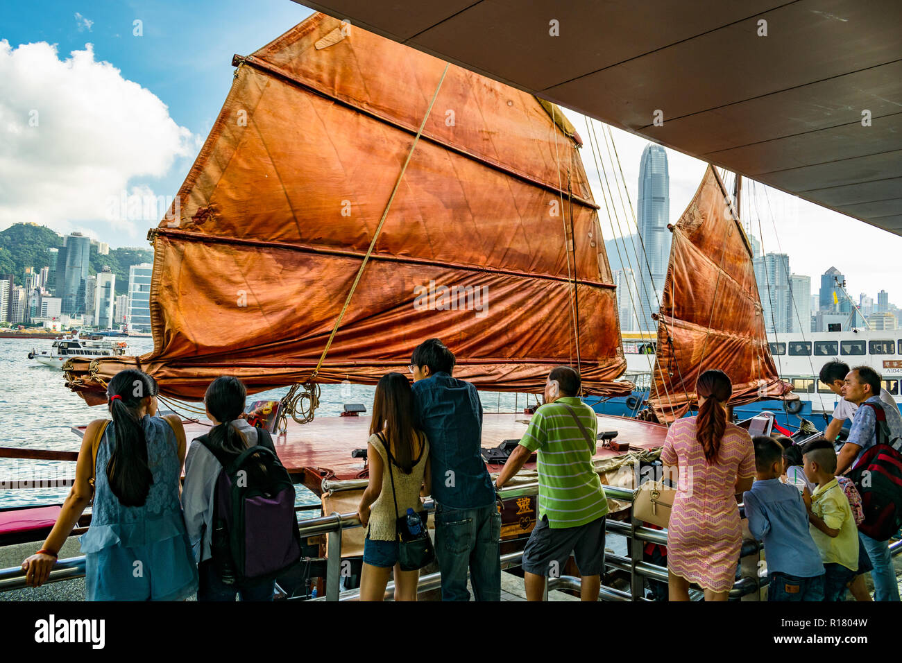 Tourists watch as junk boat Dukling (Duk Ling) with red sails in Tsim ...