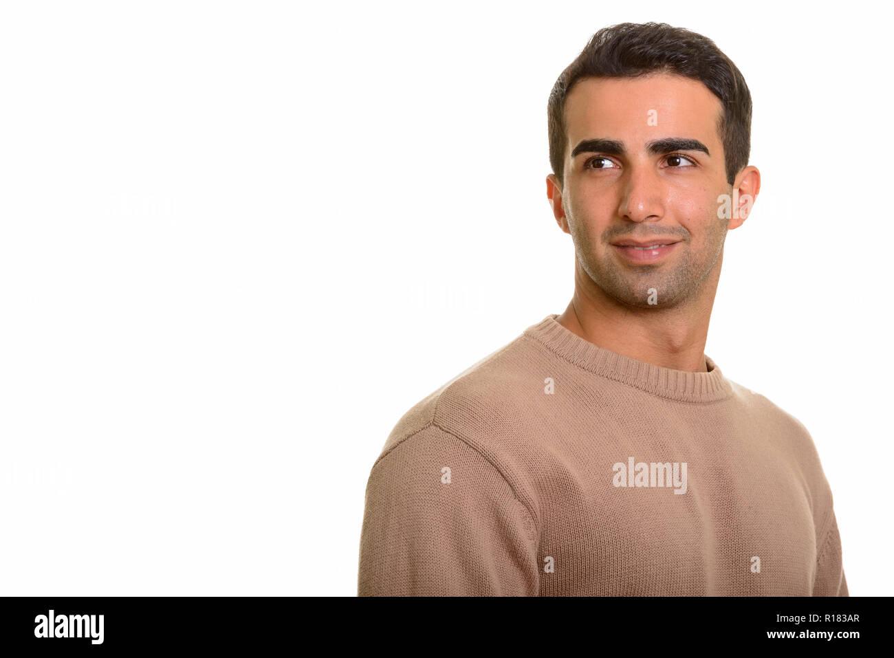 Portrait of young handsome Persian man thinking Stock Photo - Alamy