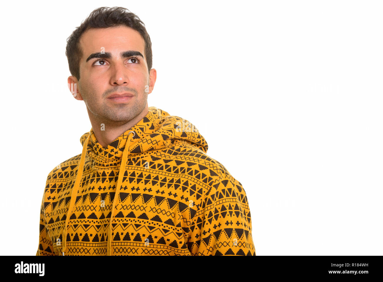 Portrait of young handsome Persian man thinking Stock Photo - Alamy