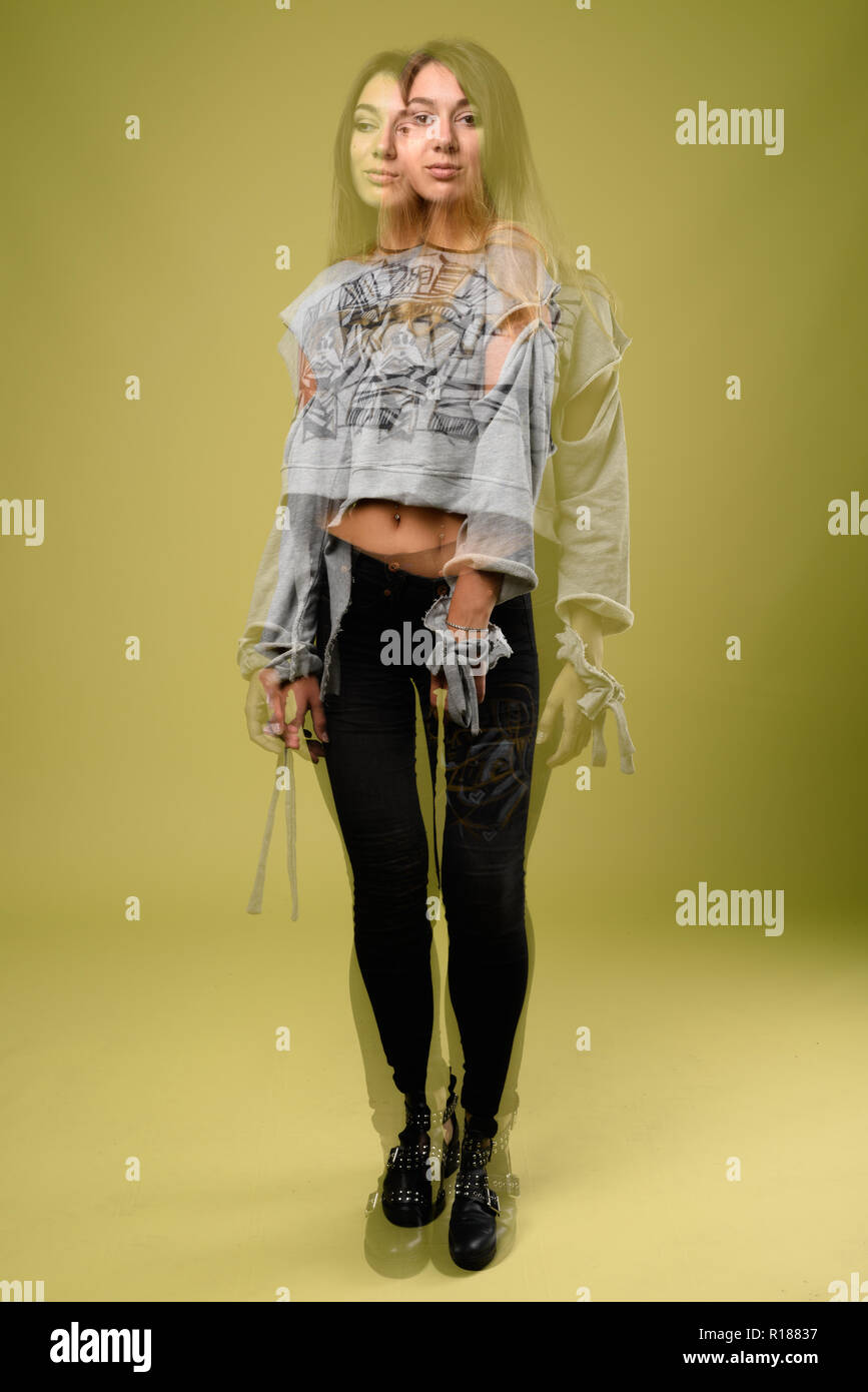 Young beautiful rebellious woman against green background Stock Photo ...