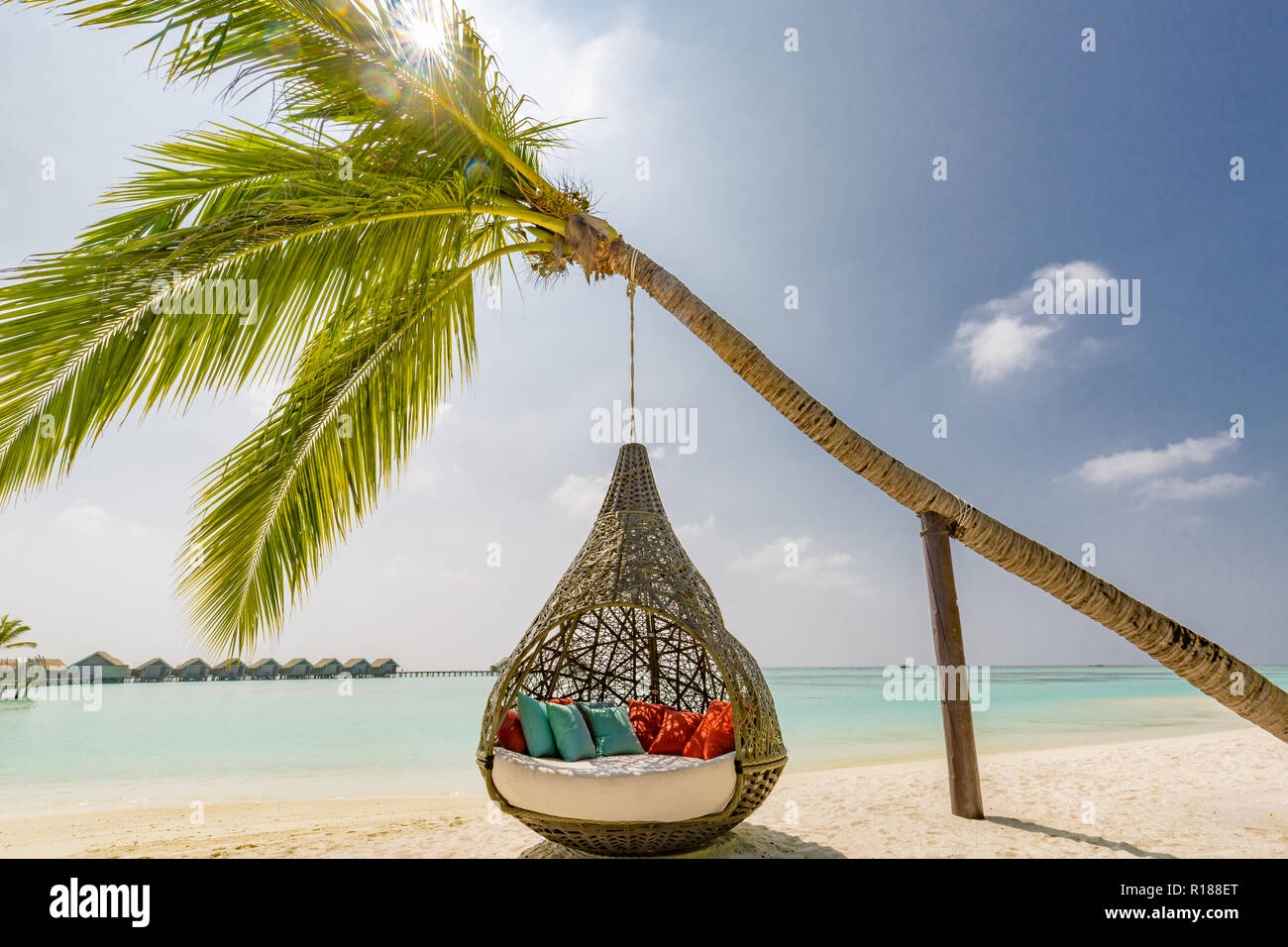 Beautiful tropical Maldives beach under cloudy sky with swings on ...