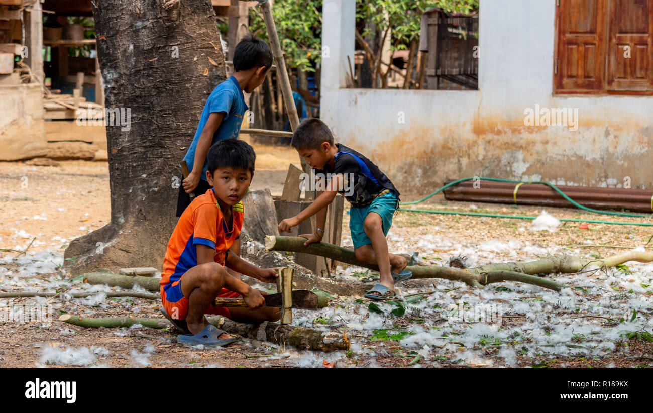 Thakhek, Laos - April 21 2018: Children working with woods in a remote ...