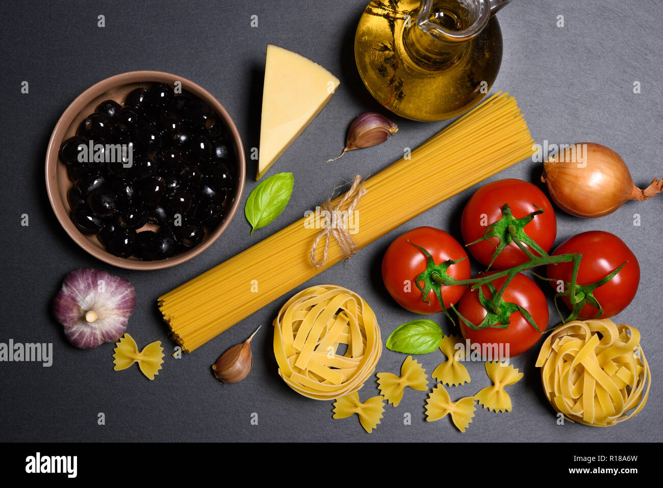 Top view: pasta or italian spaghetti on black stone slate background ...