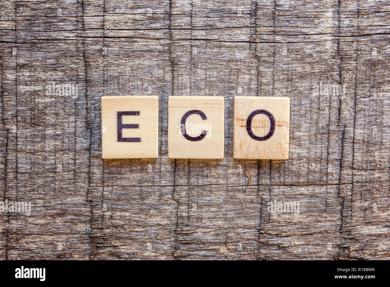 Inscription ECO letters word on old rustic wooden backdrop. Eco Village ...
