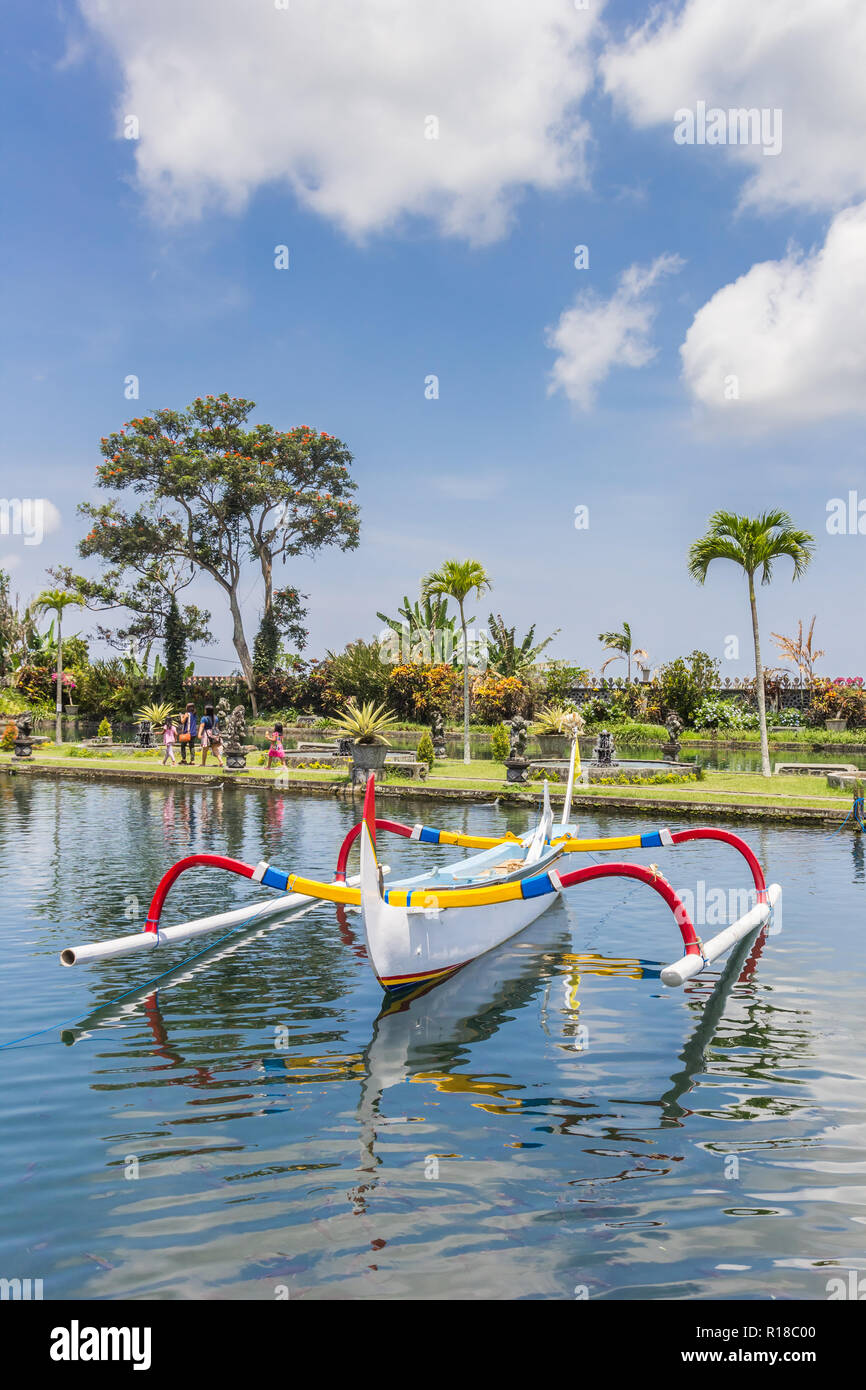 Traditional Balinese fishing boat in the pond of the Taman Tirta Gangga ...