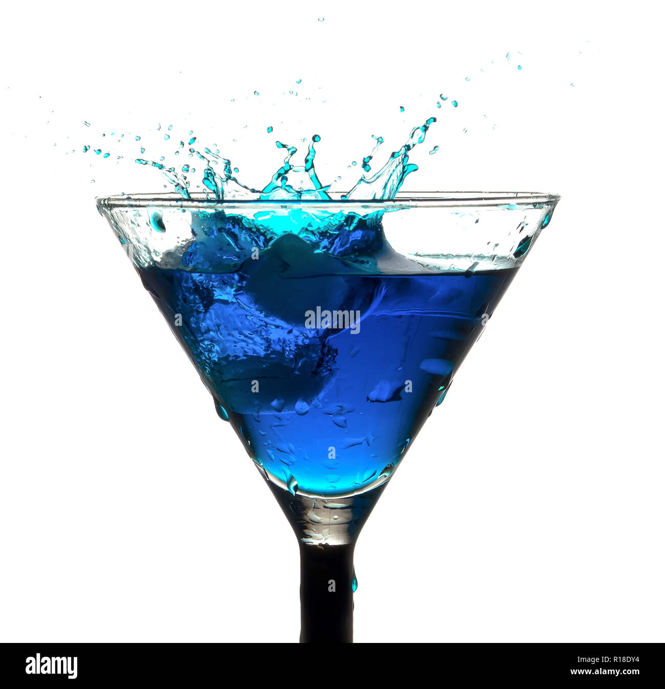 splashing out of the glass blue drink from falling ice cubes Stock Photo - Alamy