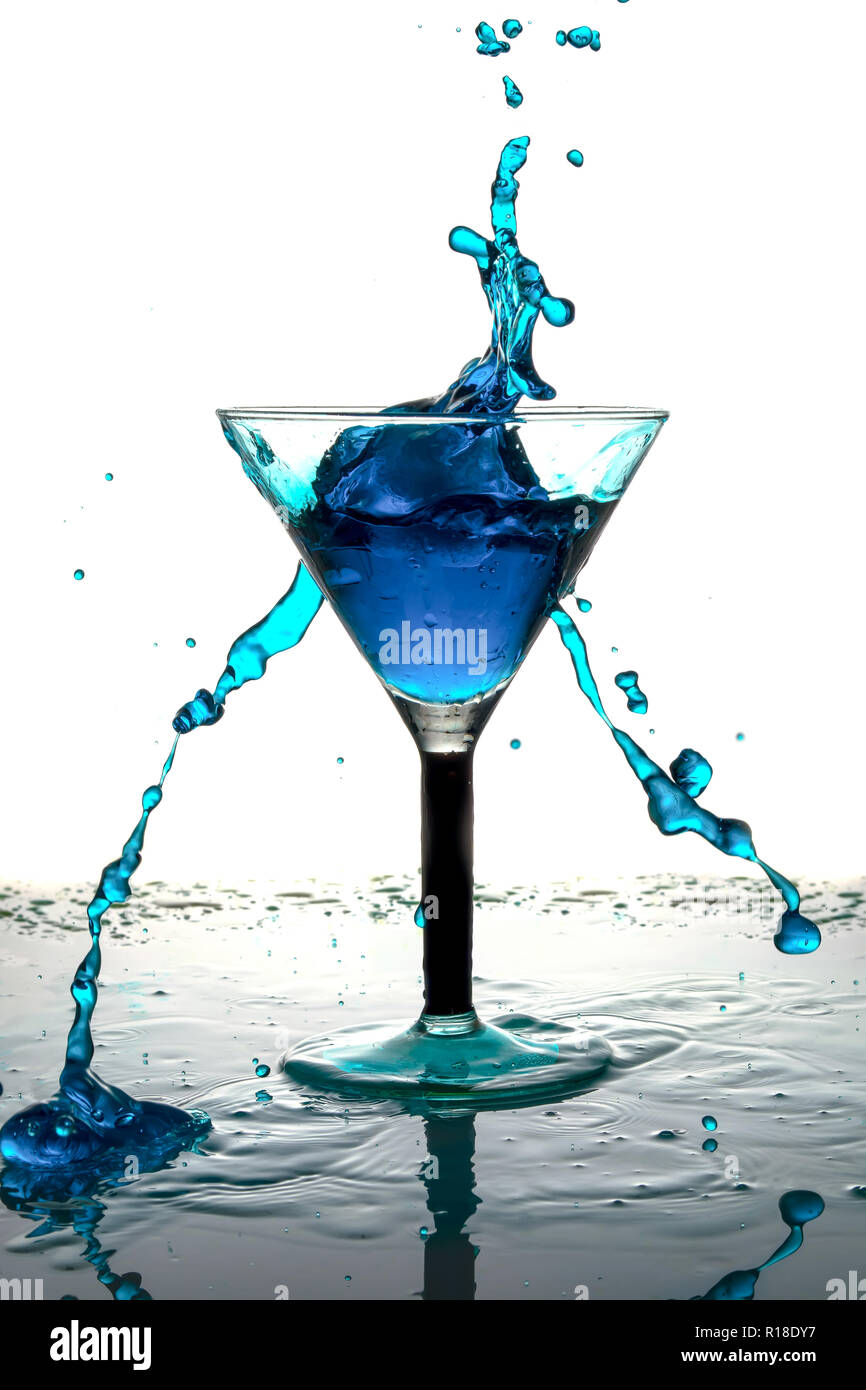 splashing out of the glass blue drink from falling ice cubes Stock ...