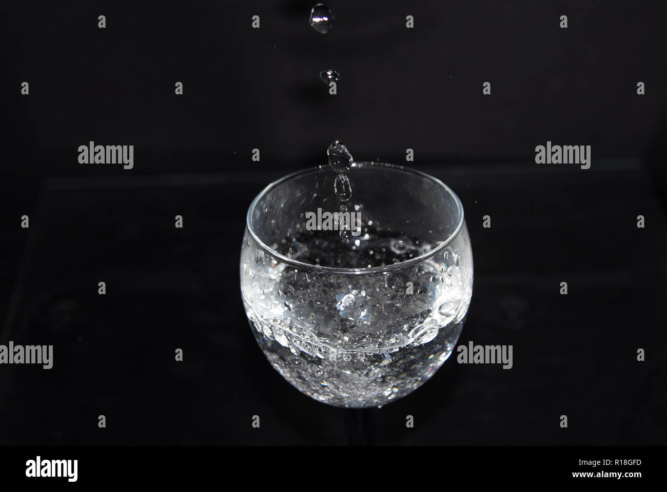 squirt, splash of water on a black background, drops Stock Photo - Alamy