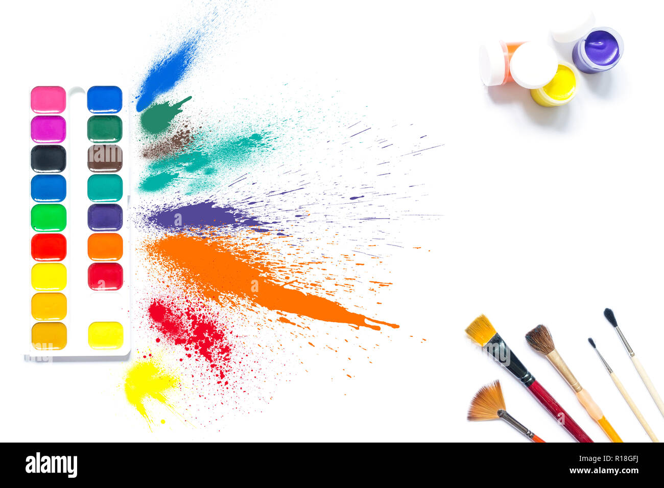 Colorful paints and brushes with multi-colored spray splash paint ...