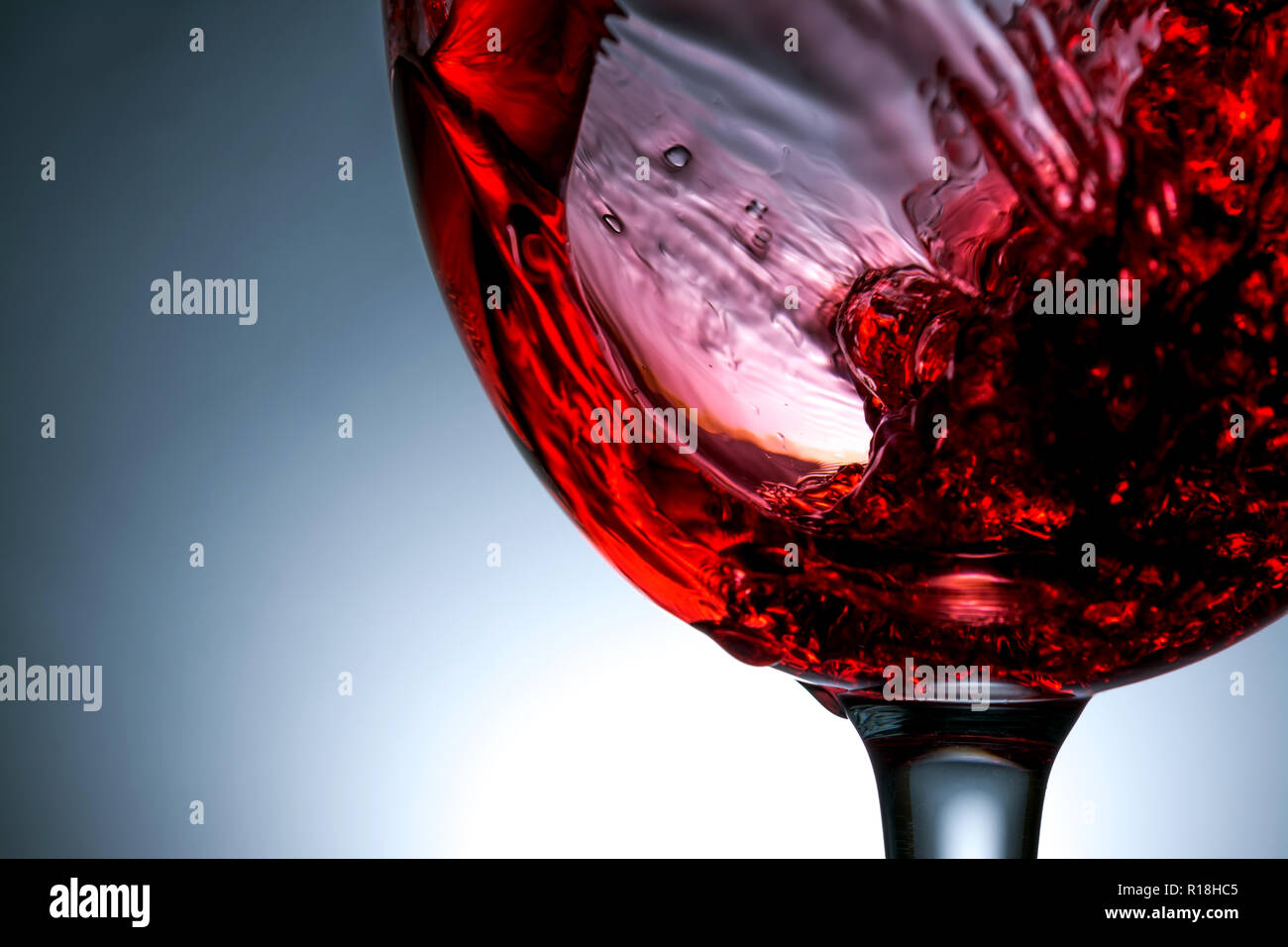 stream of wine being pouring into a glass closeup, wine, splashing ...