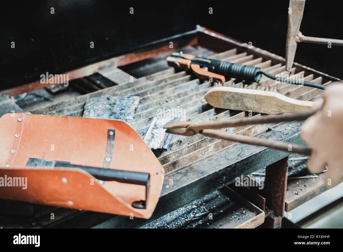 Asian engineering student doing metal work in workshop class using ...
