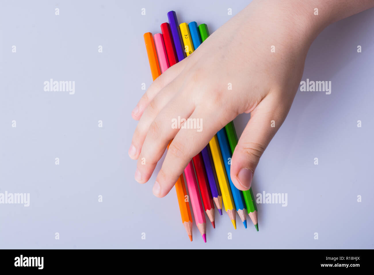 Hand holding color Pencils placed on a white background Stock Photo - Alamy