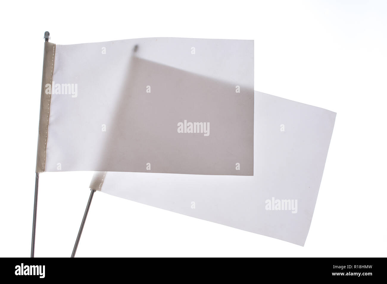 Two white flags on a white background in the display Stock Photo - Alamy