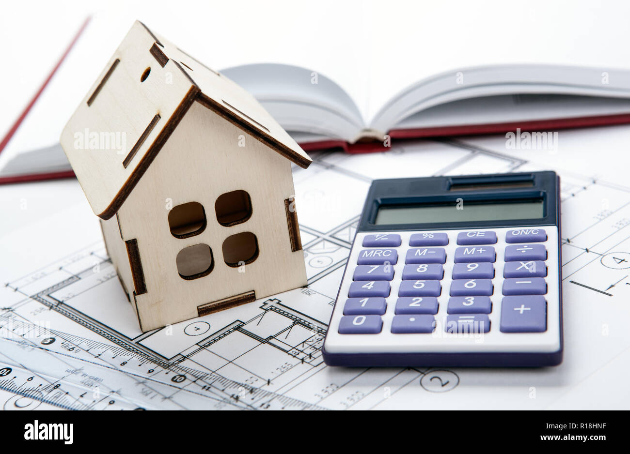 wooden miniature house with a calculator and drawing close up Stock ...