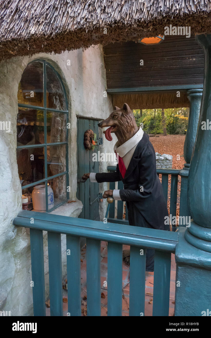 Big Bad wolf in suit with tie standing in front of door of house in the ...