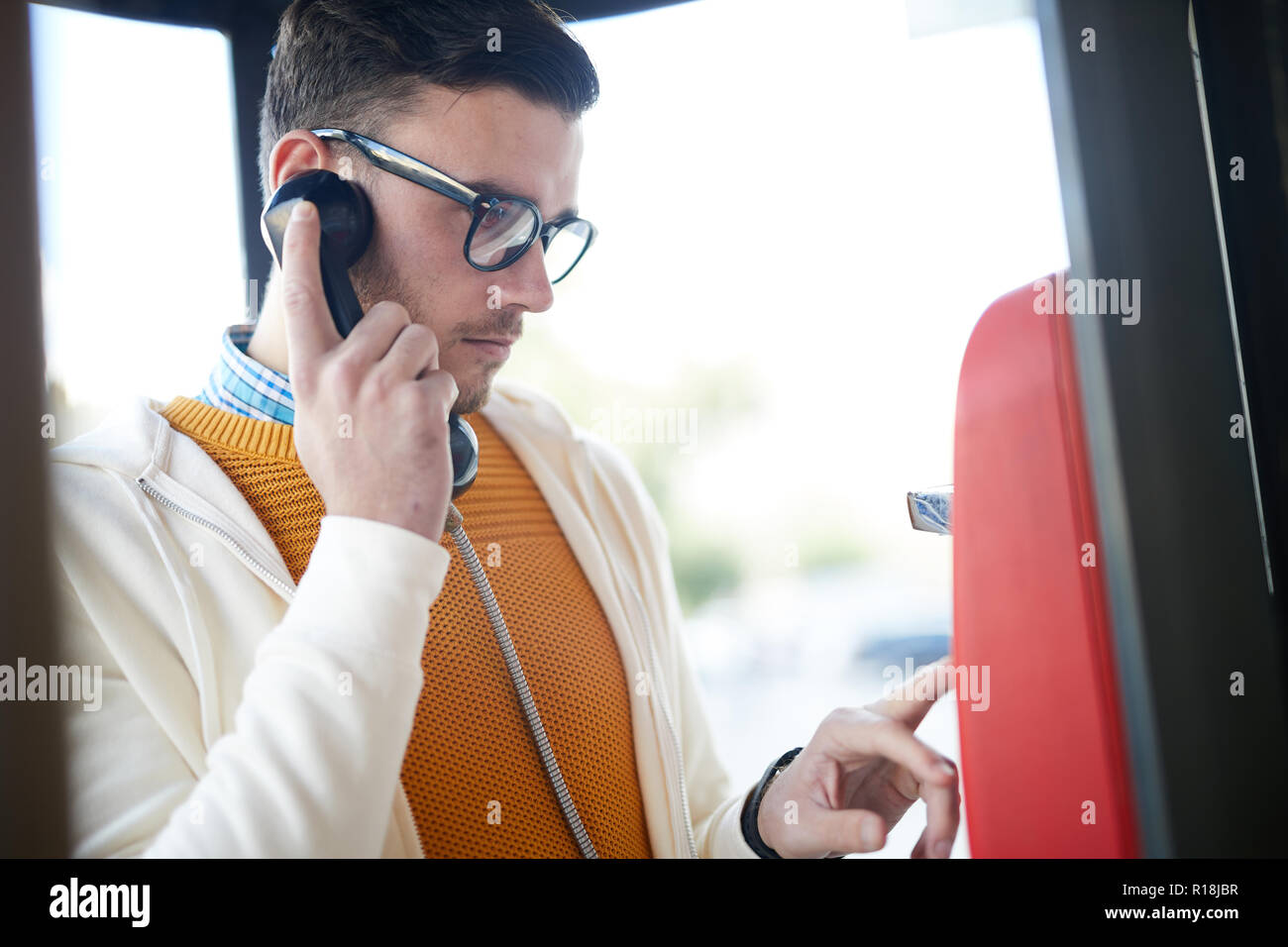 Standing in phone booth hi-res stock photography and images - Alamy