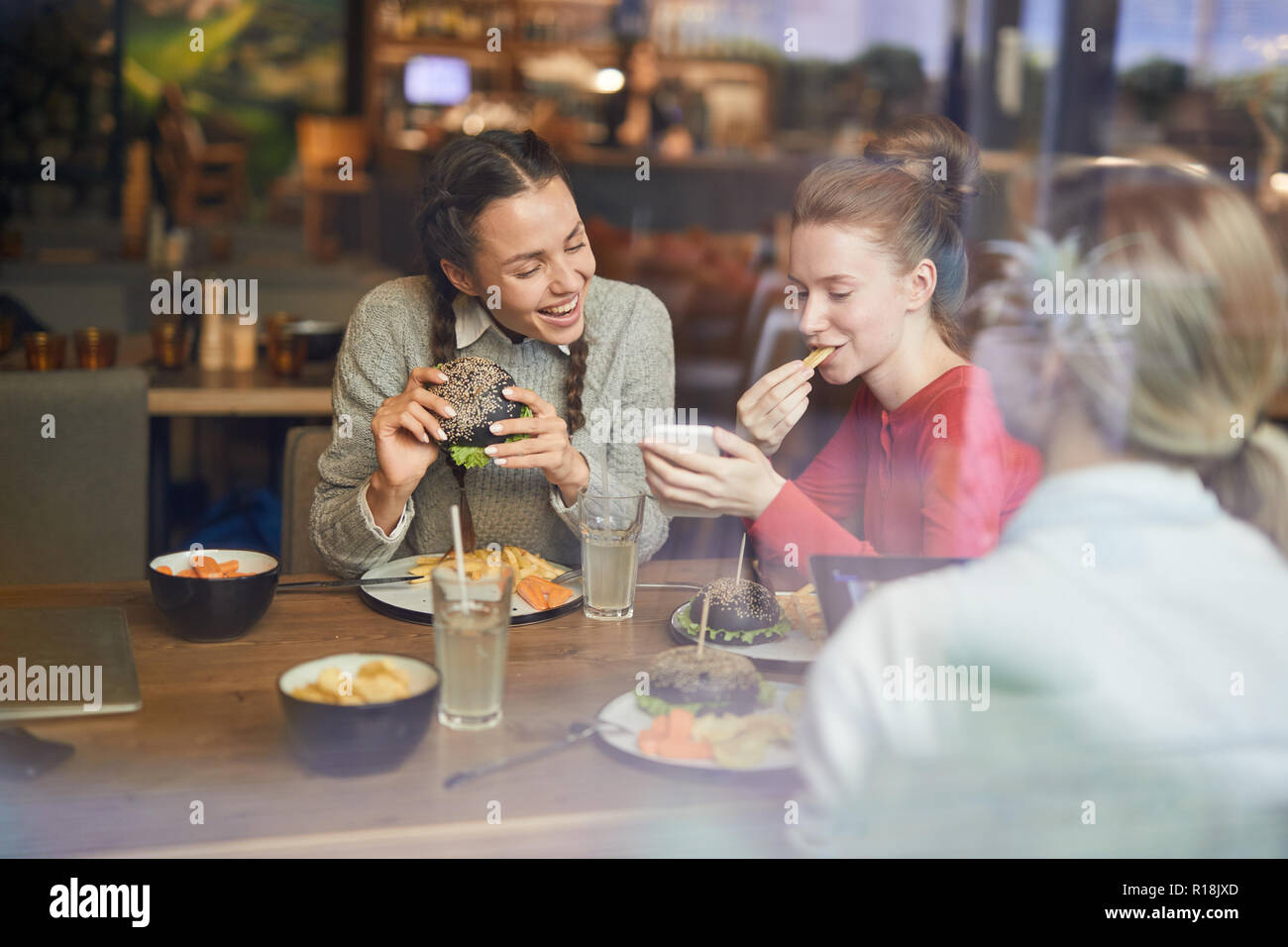 Cute girls making funny selfie by lunch while spending time in fast ...