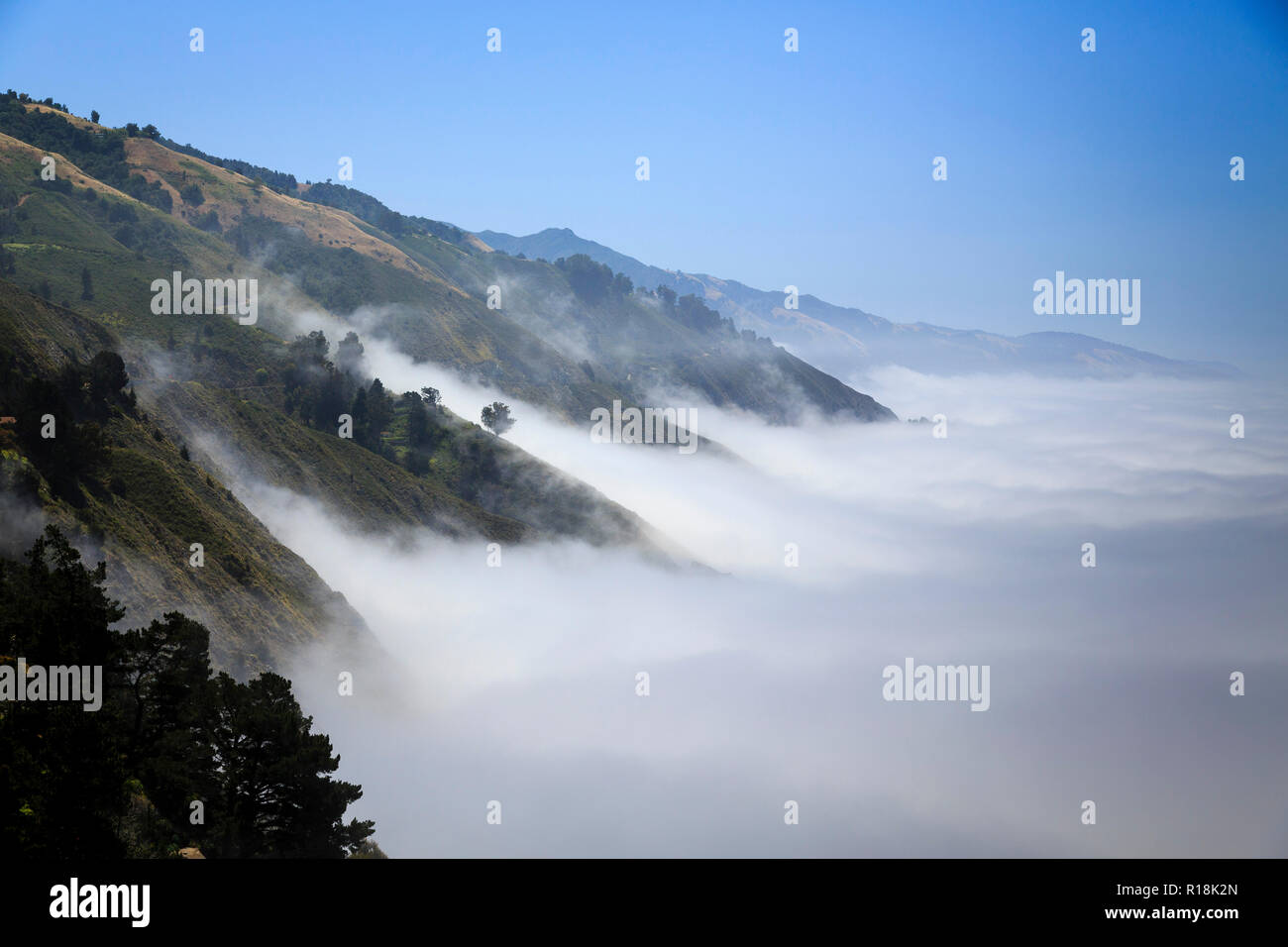 Pacific ocean fog fills the coastal valleys on Big Sur, California ...